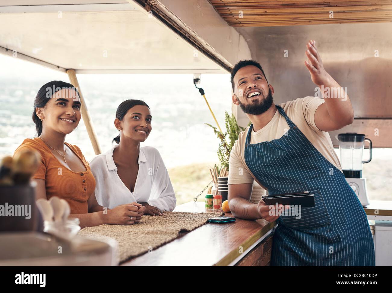 What would you like today. two friends ordering food from a food truck ...