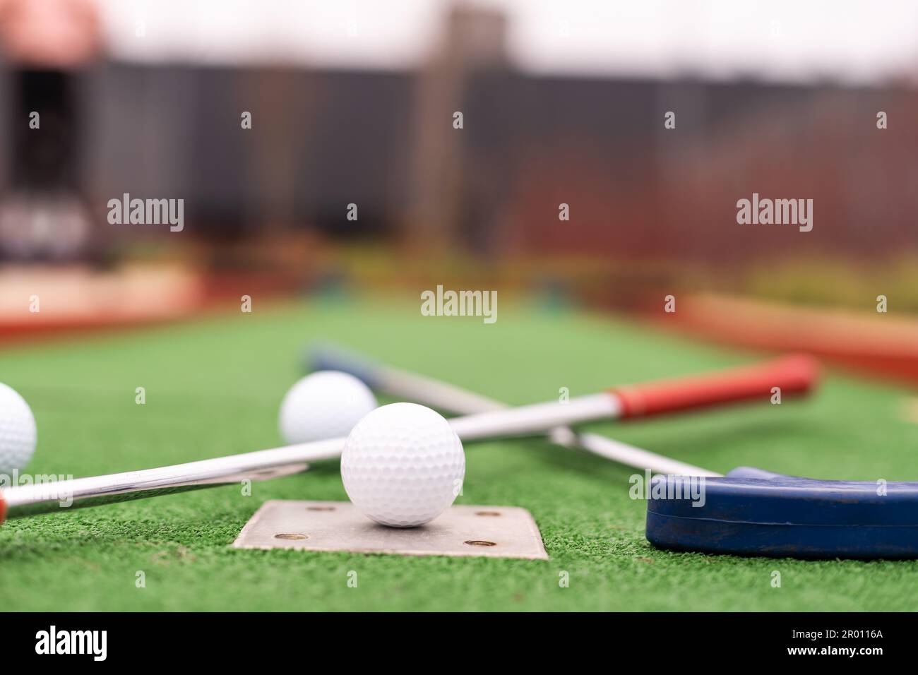 Mini golf close-up, colorful golf putters, balls Stock Photo - Alamy