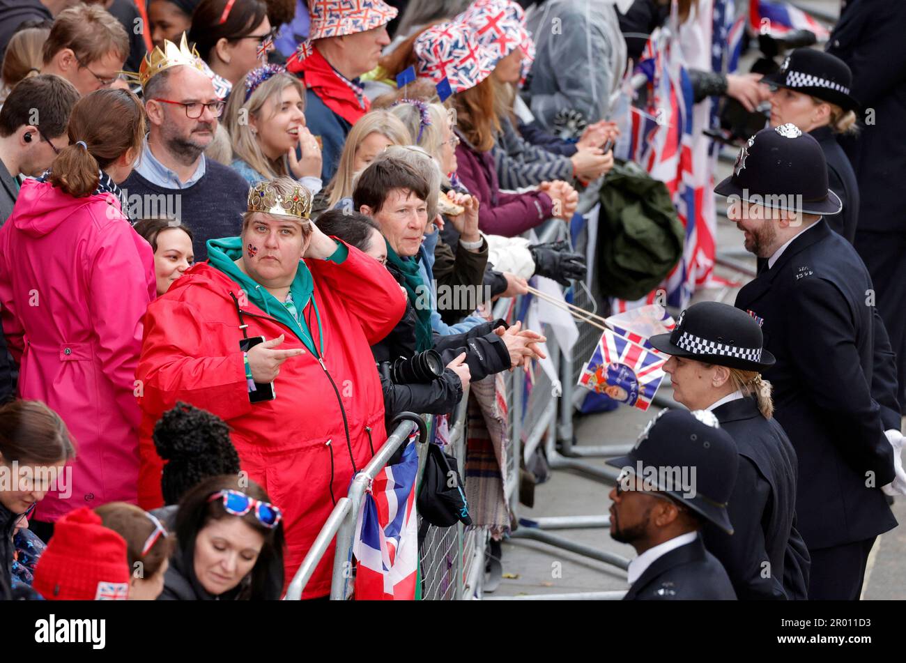 People gather as they wait to watch Britain's King Charles III ...