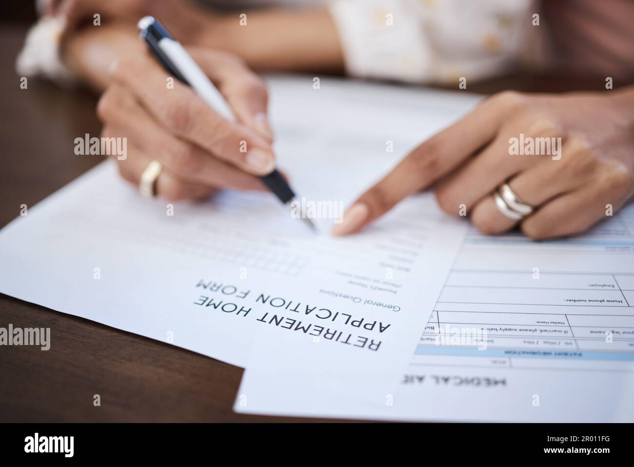 Retirement planning in progress. a woman going over paperwork with her ...