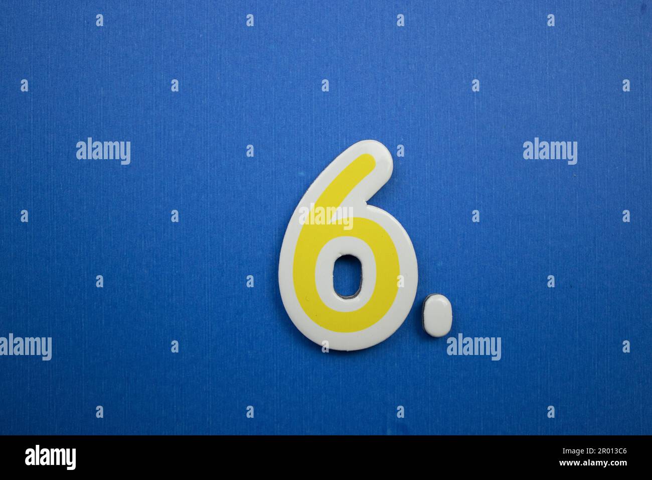 The number 6, yellow and white, placed on a blue background ...
