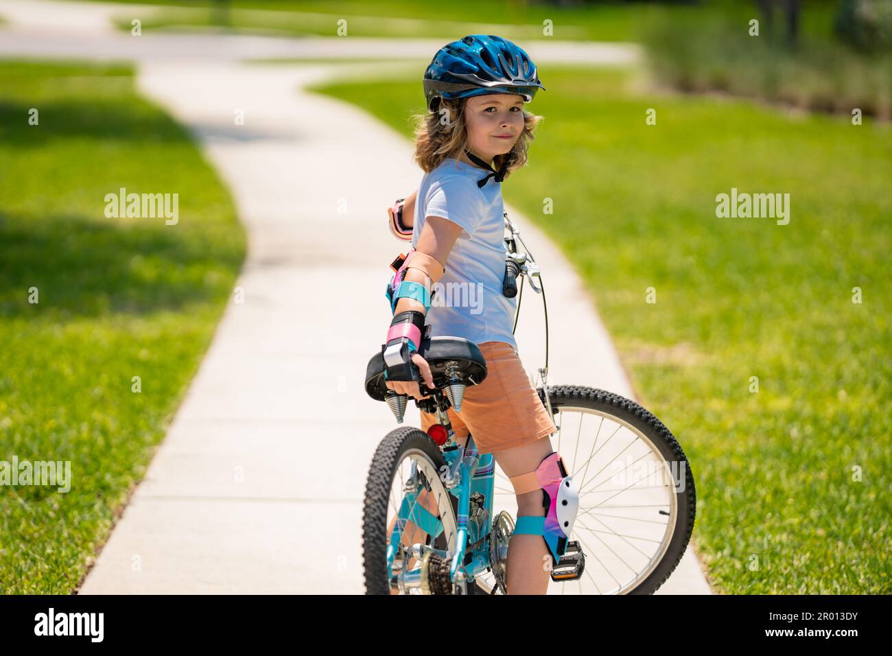 Kid learning to ride bike. Child riding bicycle. Little kid boy in ...