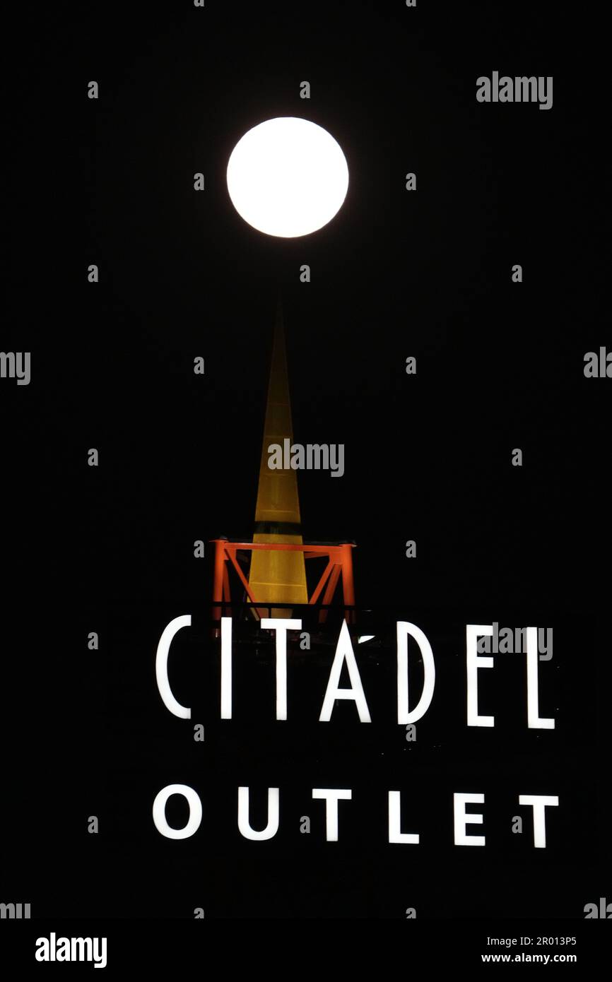 A full moon rises over the Citadel Outlets shopping mall, Friday, May 5 ...