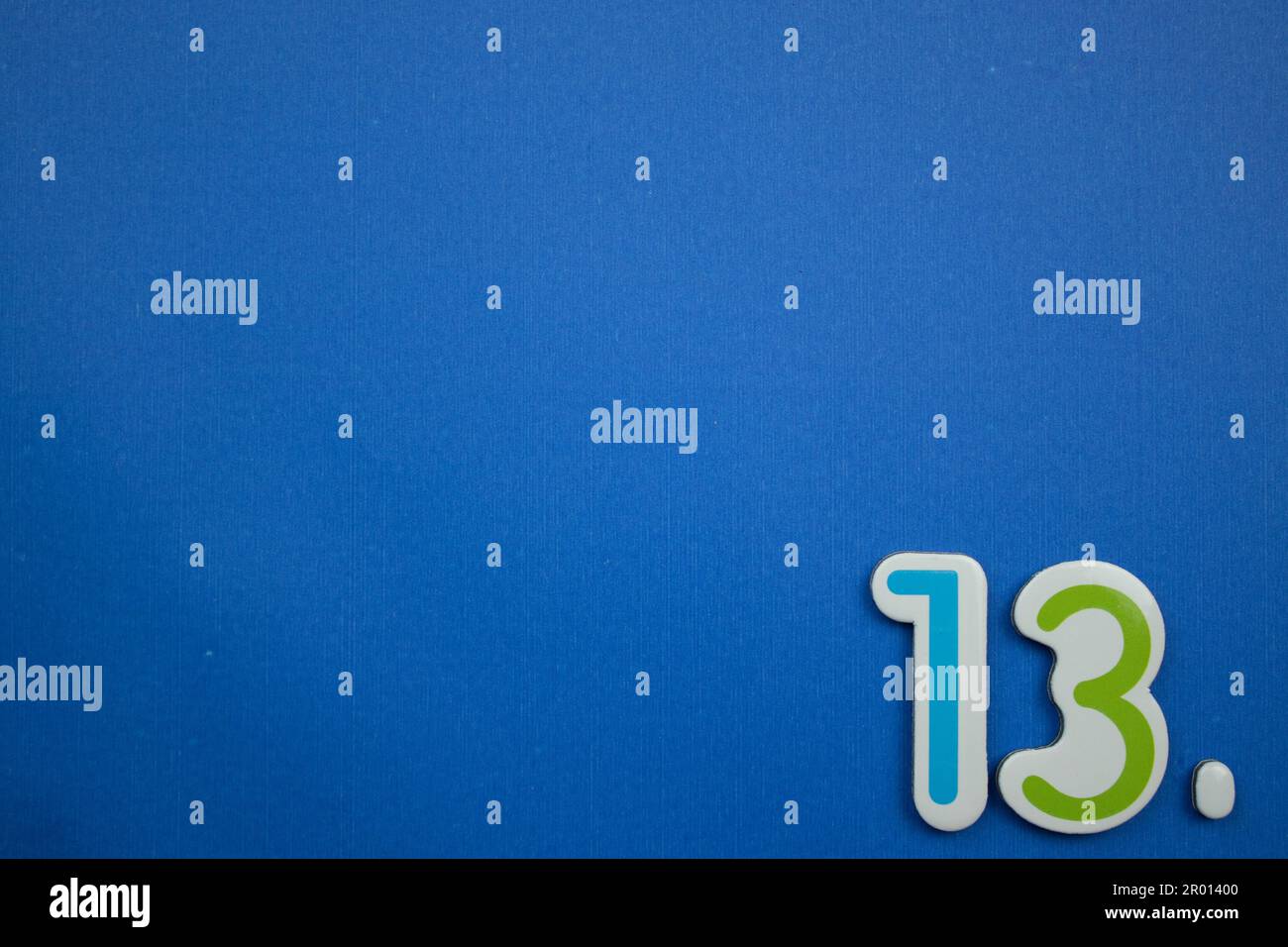 The number 13 in light blue and green color, photographed from above ...