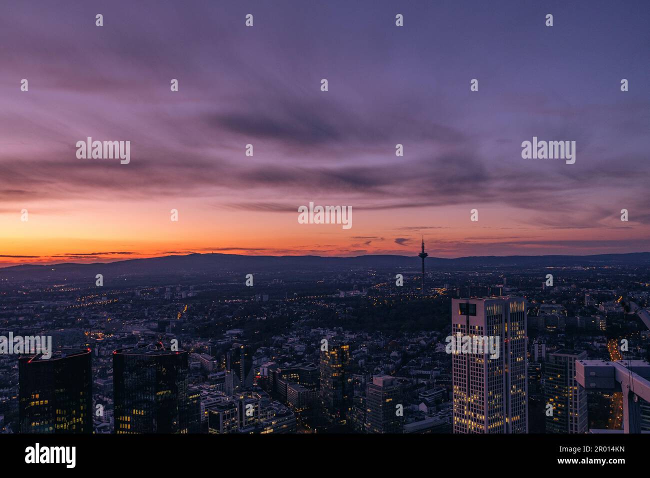 View over the city under the sunset sky Stock Photo - Alamy
