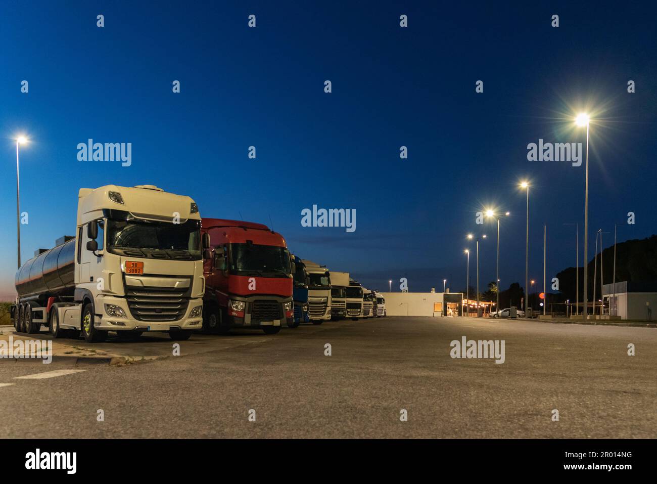 Trucks resting in a highway service area at night Stock Photo - Alamy