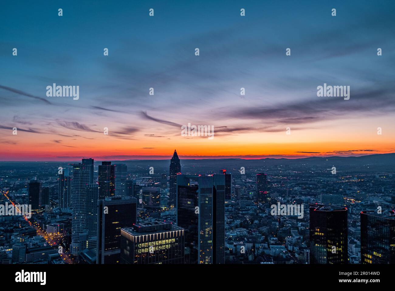 View over the city under the sunset sky Stock Photo - Alamy