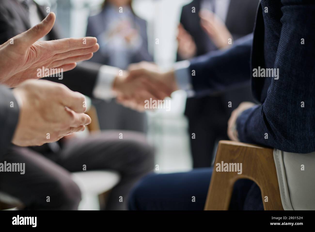Business colleagues shaking hands in an office hallway Stock Photo - Alamy