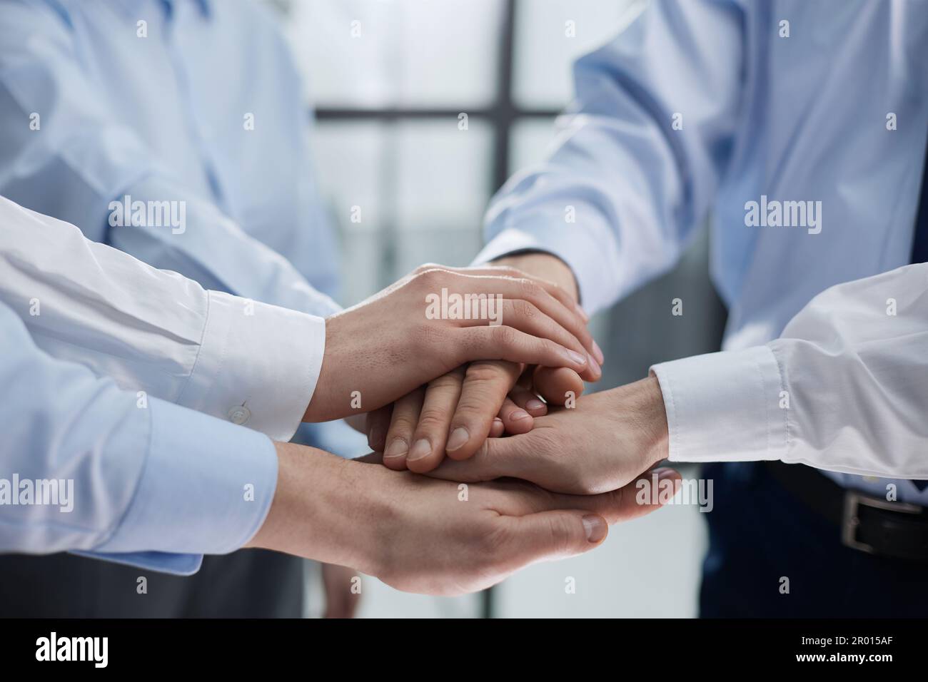 Close up on colleagues hands all together Stock Photo - Alamy