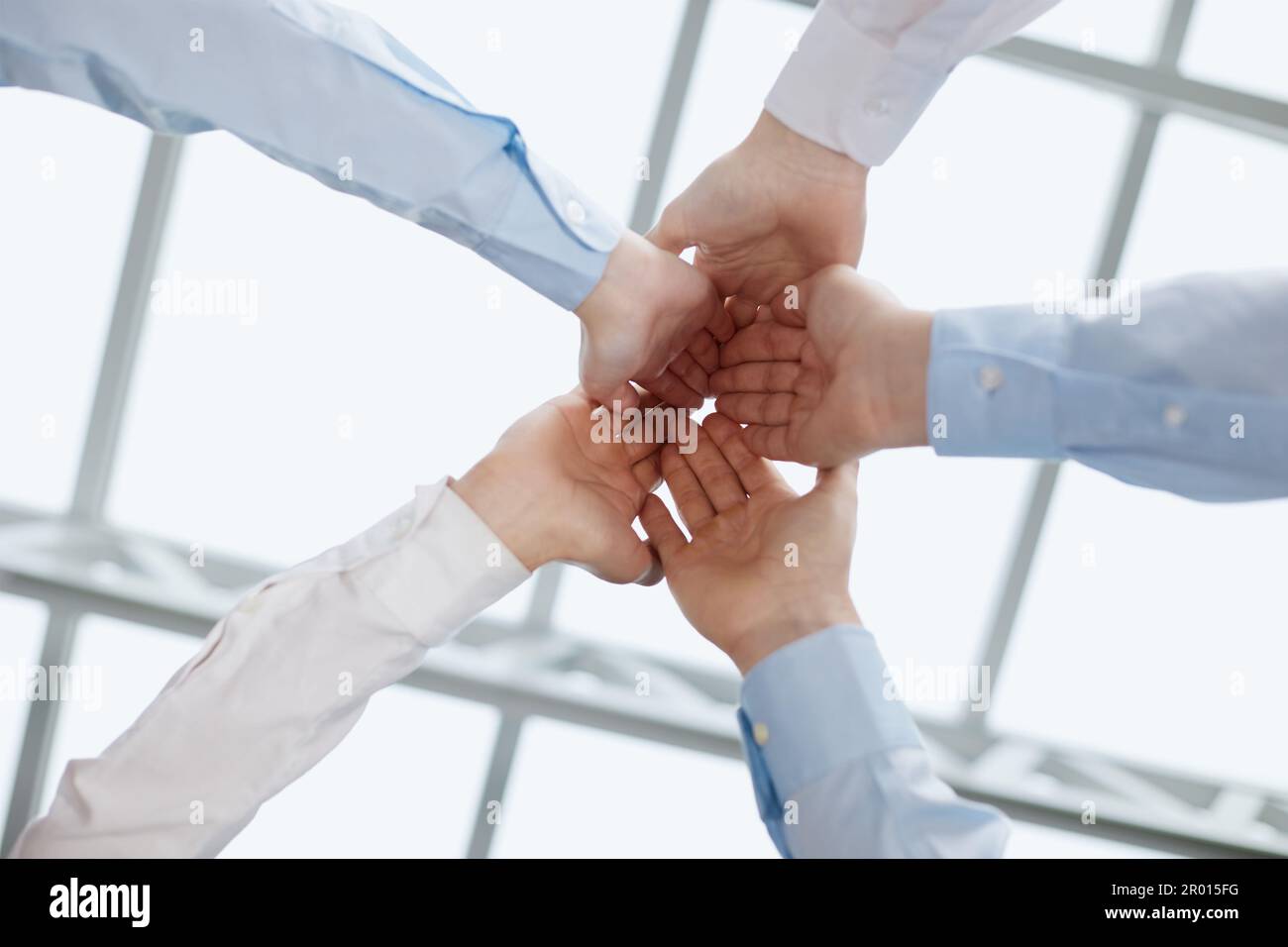 Huddle hands together support hi-res stock photography and images - Alamy