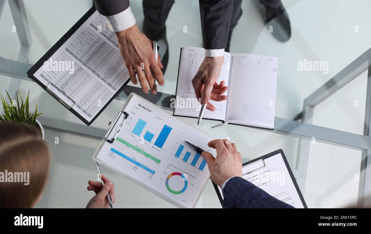 Business team analyzing income charts and graphs. Top view photo shoot ...