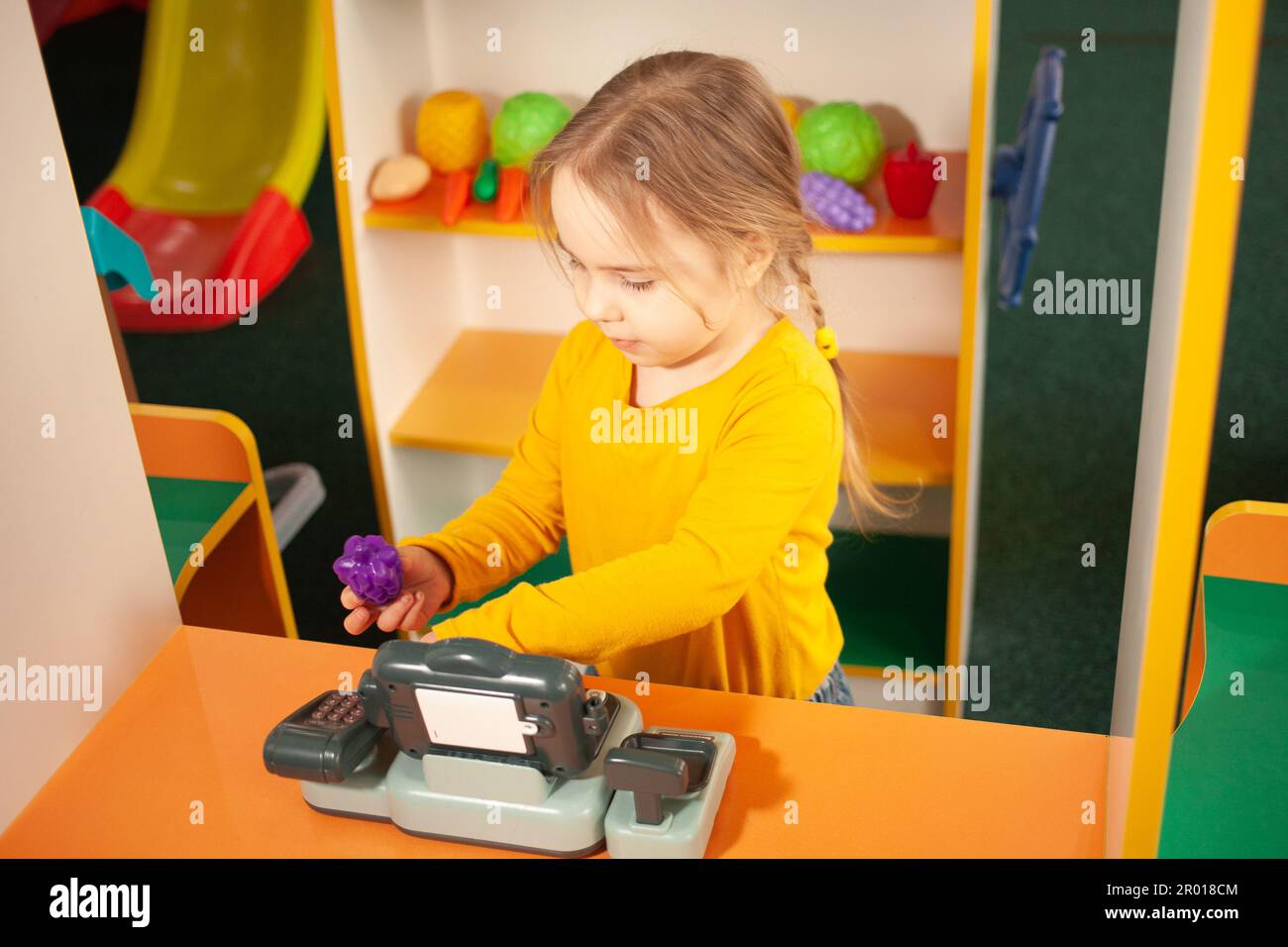 child in kindergarten, playroom, playing with toys, learning. Plays in ...