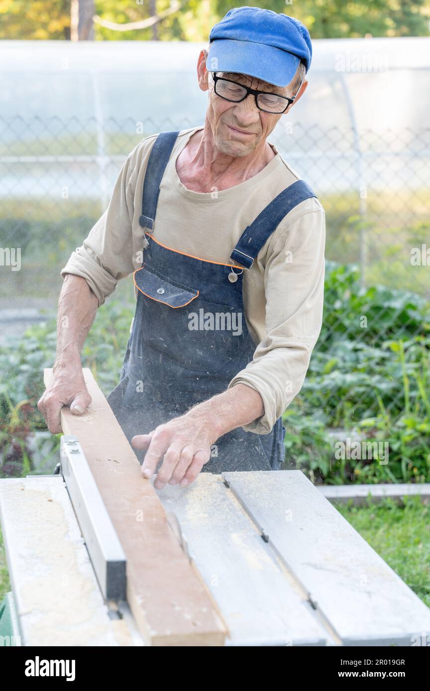 Work on the infield. Do it yourself. A carpenter processes wooden ...