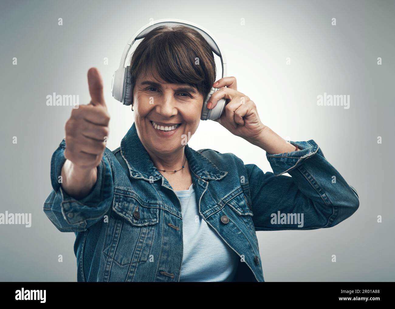 Good music just gets you. Studio portrait of a senior woman showing ...