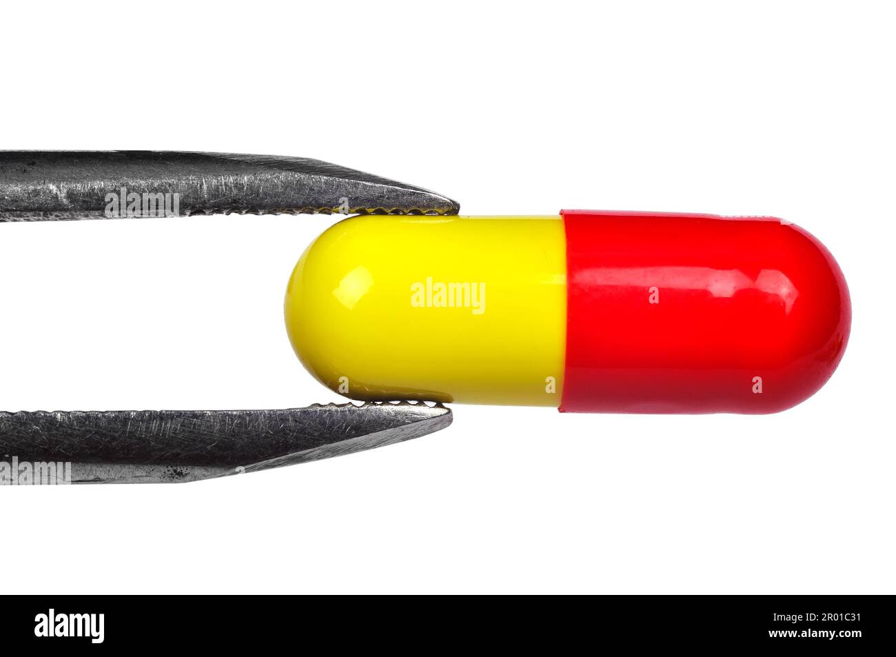 color capsule in tweezers on a white background Stock Photo - Alamy