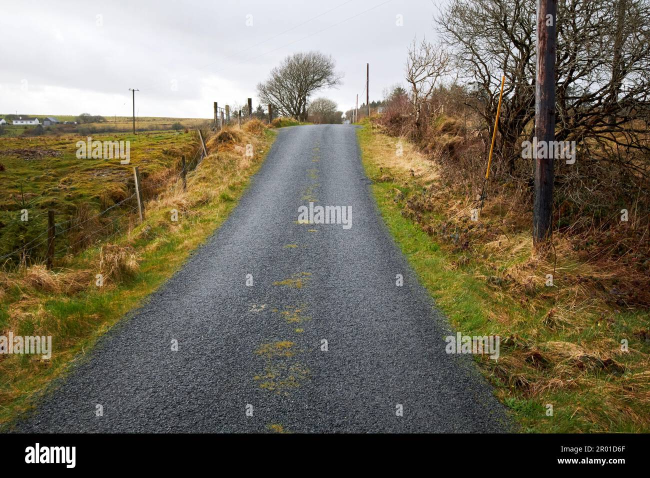 resurfaced rough tarmac road over crest in rural county donegal ...