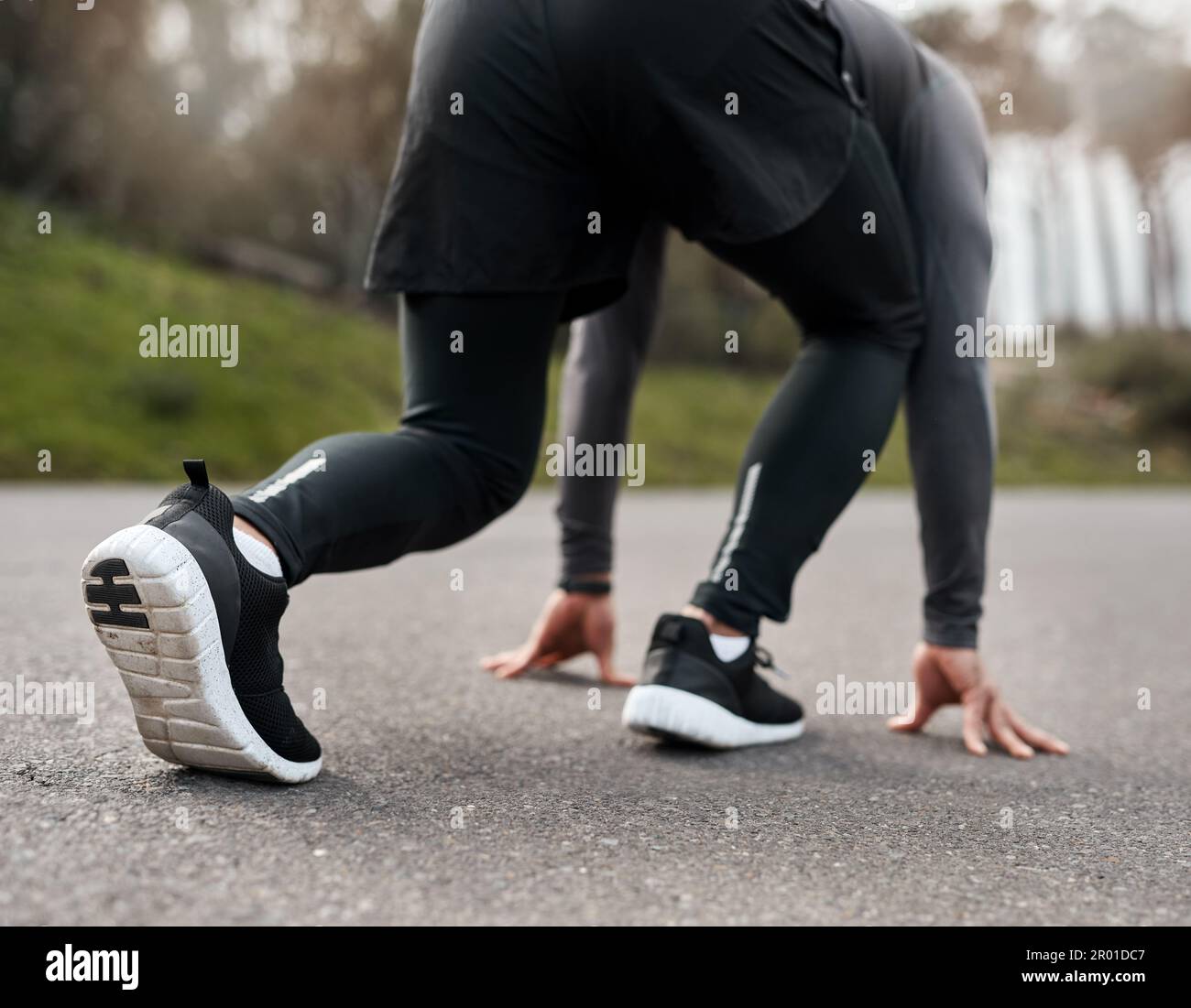 Stay focused and on track. an unrecognizable man crouched down in a ...