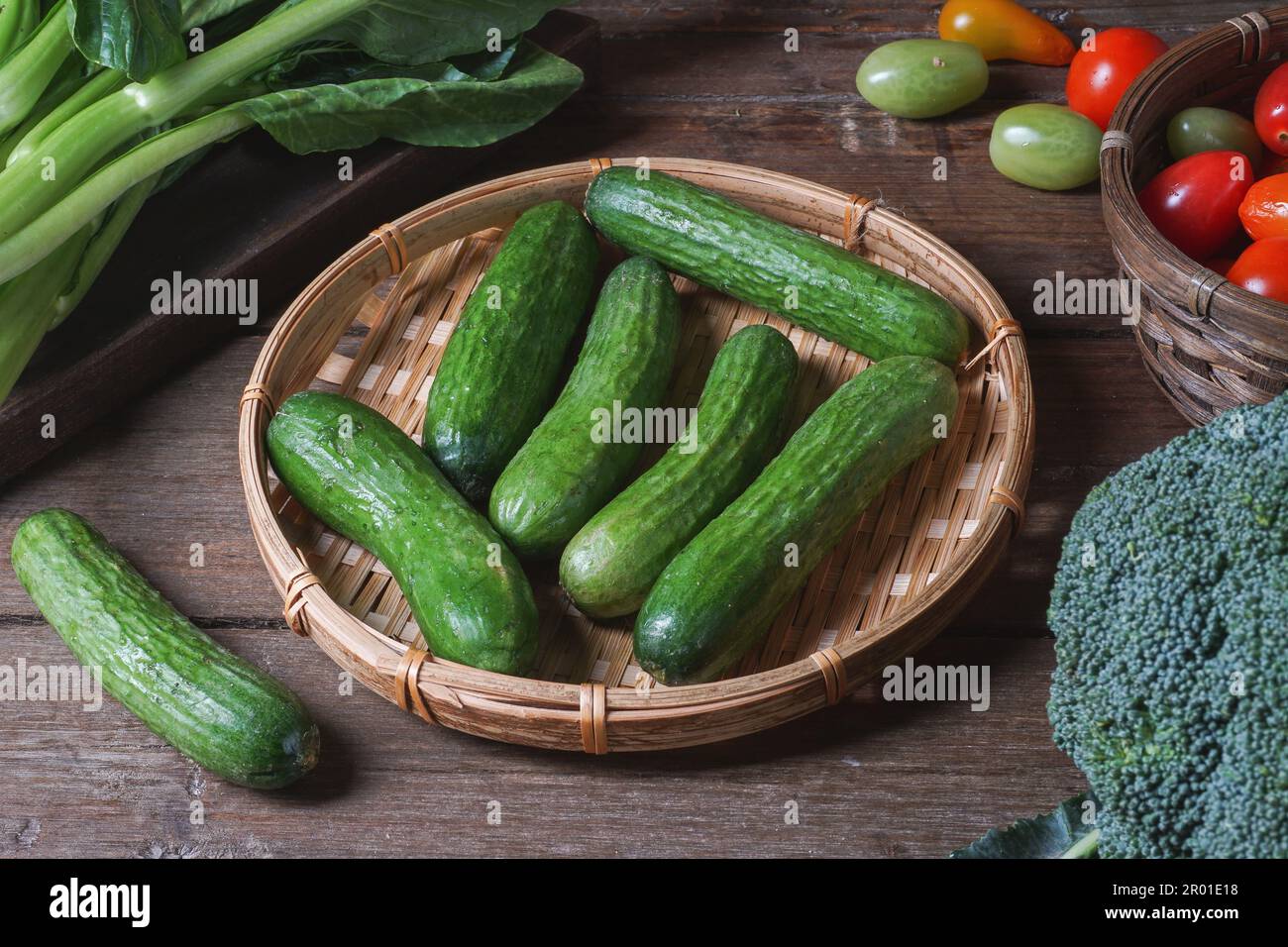 Fresh crunchy mini cucumbers in a bamboo basket Stock Photo - Alamy