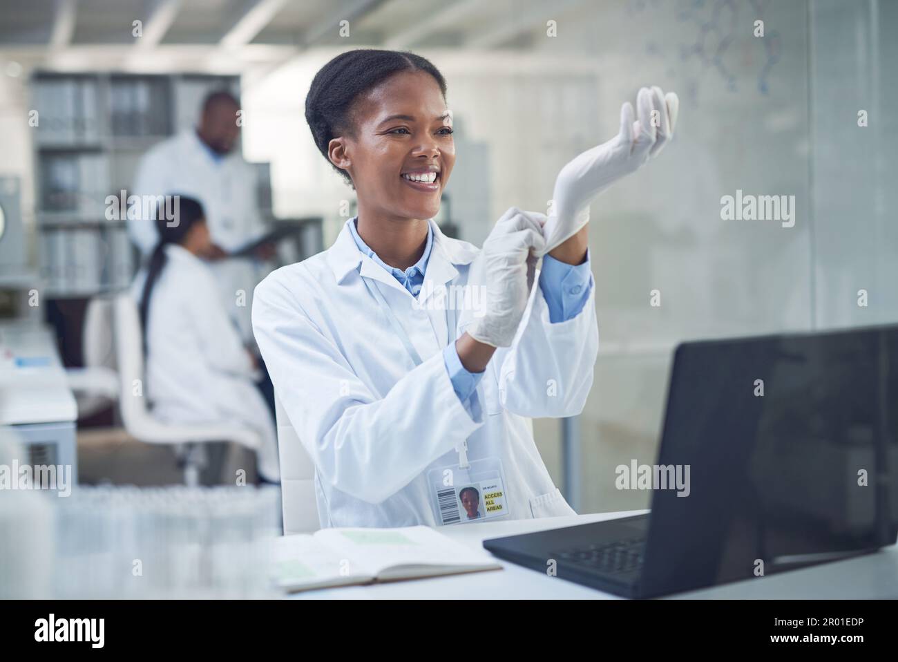 Stand back and watch science unfold. a young scientist putting on ...