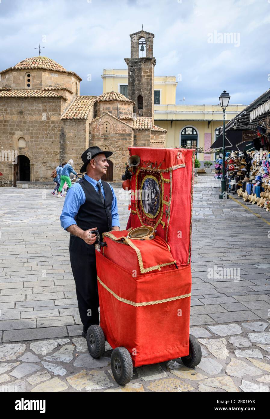 An organ grinder performing in the 23rd Of March Square, in front of ...