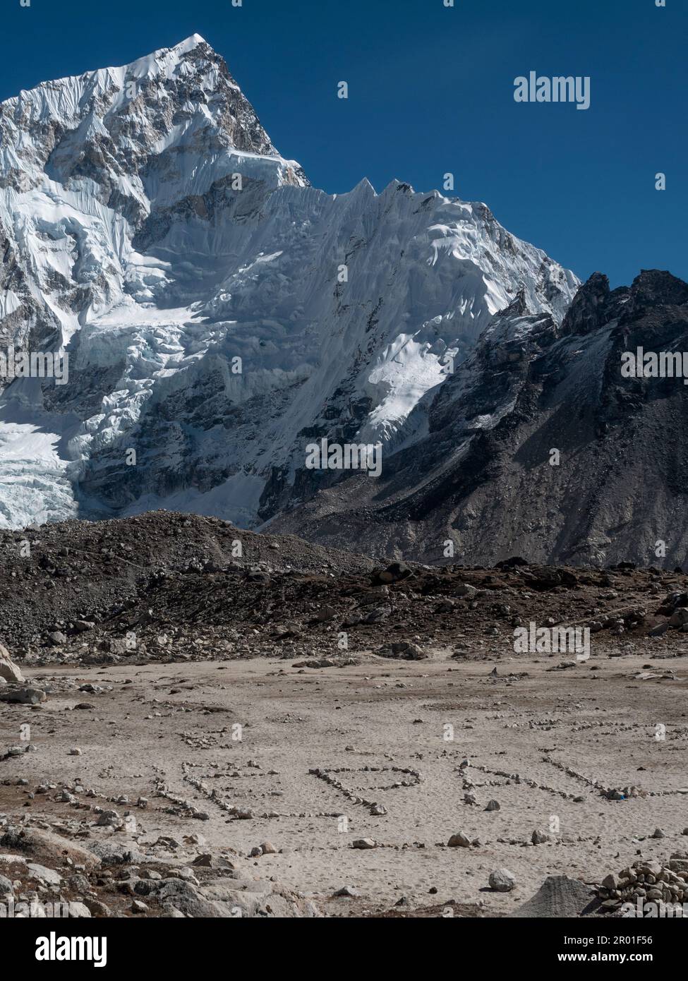Nepal written with stones and 7861meters Nuptse mountain in the ...