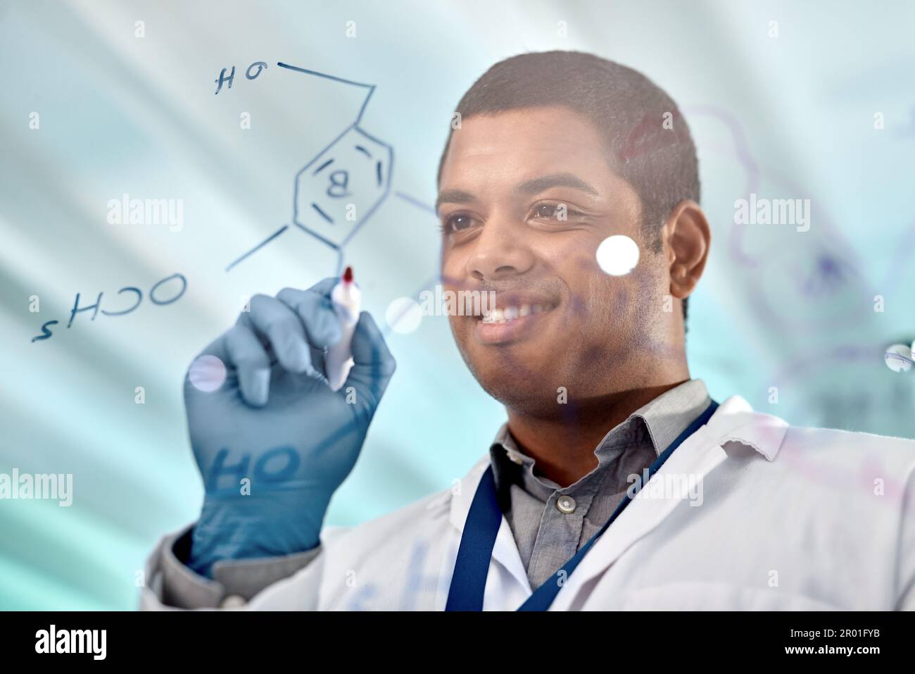 Figuring a new formula. a young scientist drawing molecular structures ...