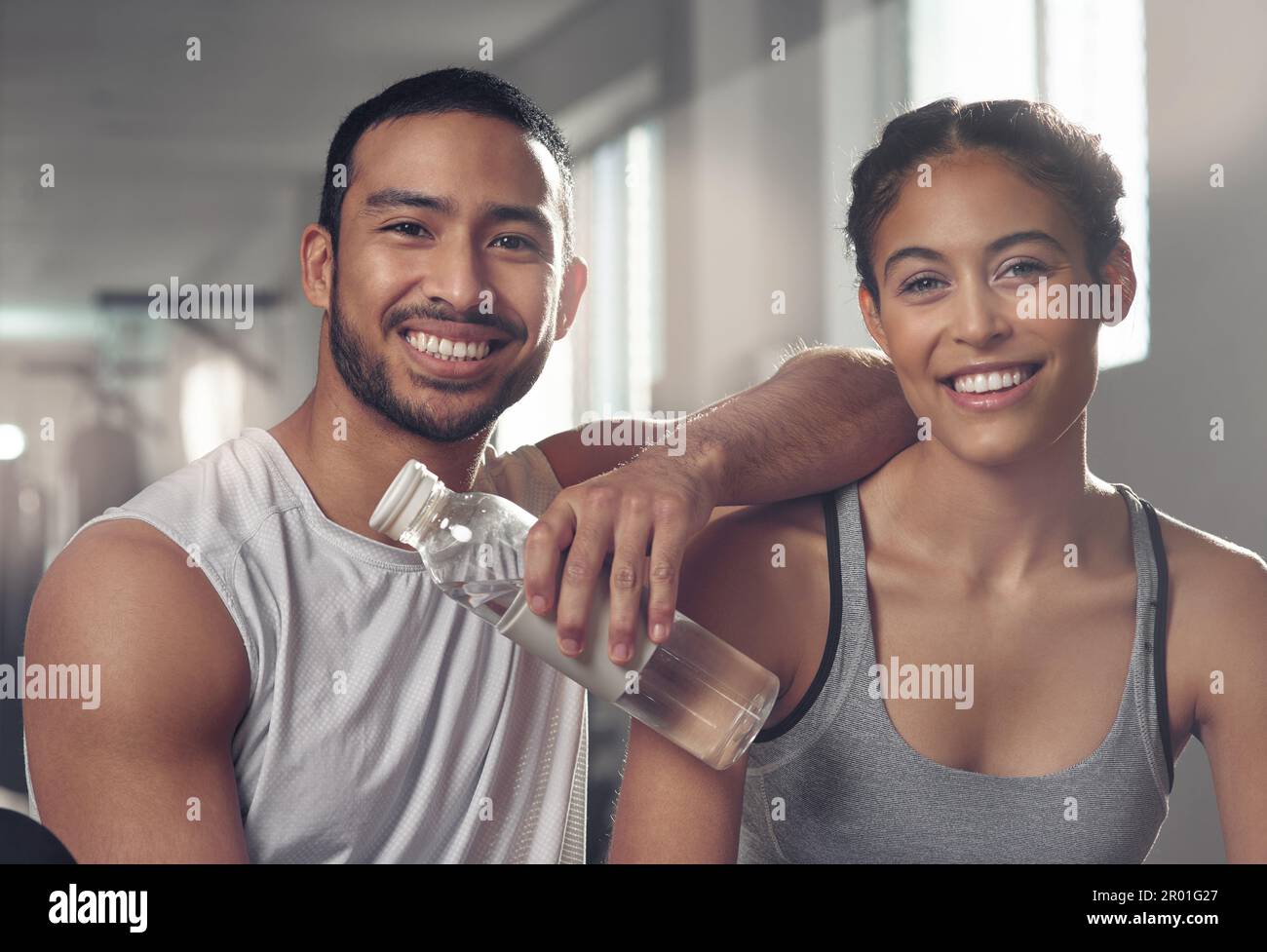 We wake up ready to hit the gym. two young athletes sitting together at ...
