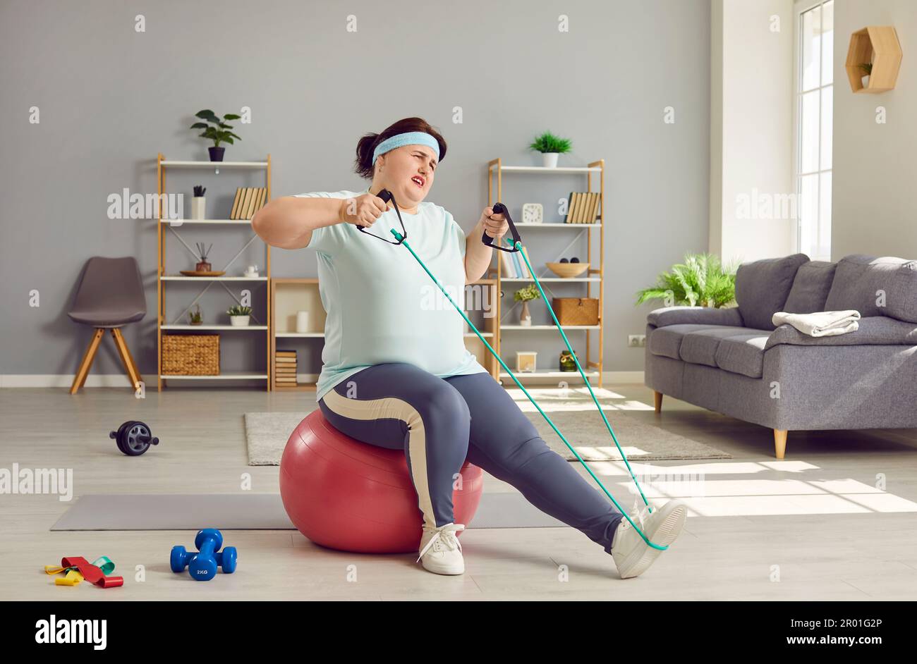 Funny fat woman sitting on fit ball at home and doing exercise with ...