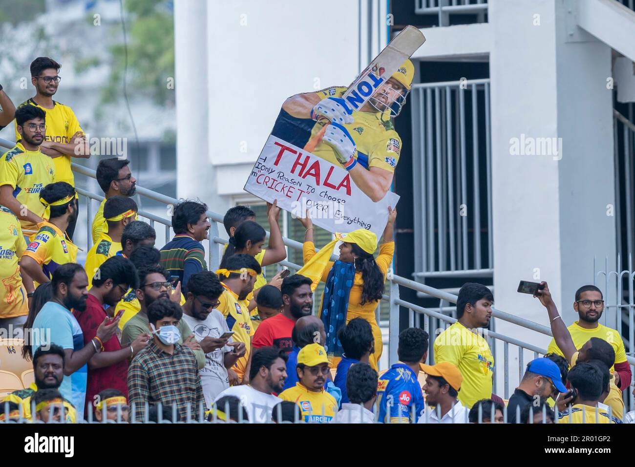 Fans of Chennai Super Kings' captain MS Dhoni hold a placard carrying his portrait during their ...