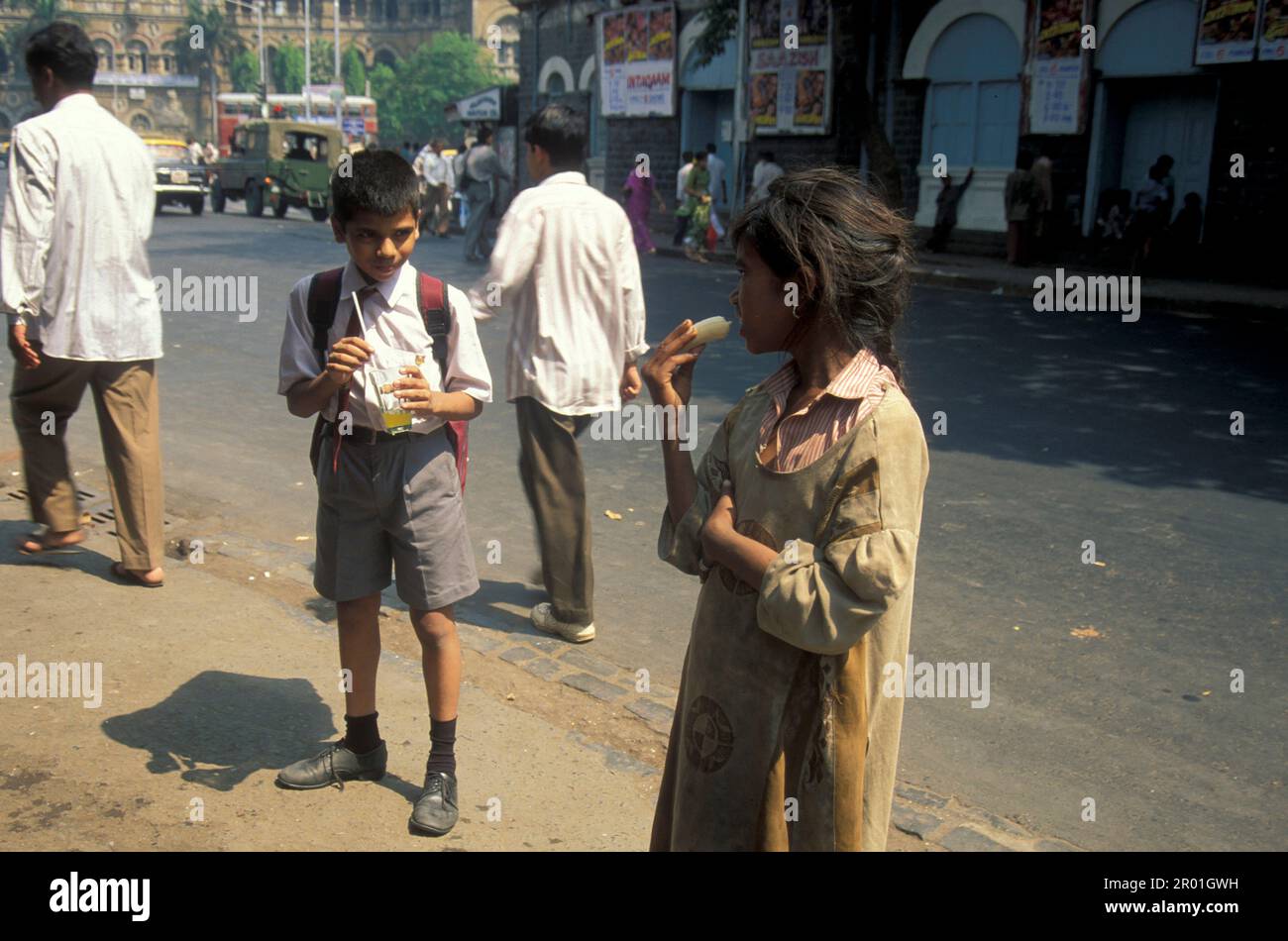 a school Boy and a poor girl meet in front of the Mumbai Railway ...