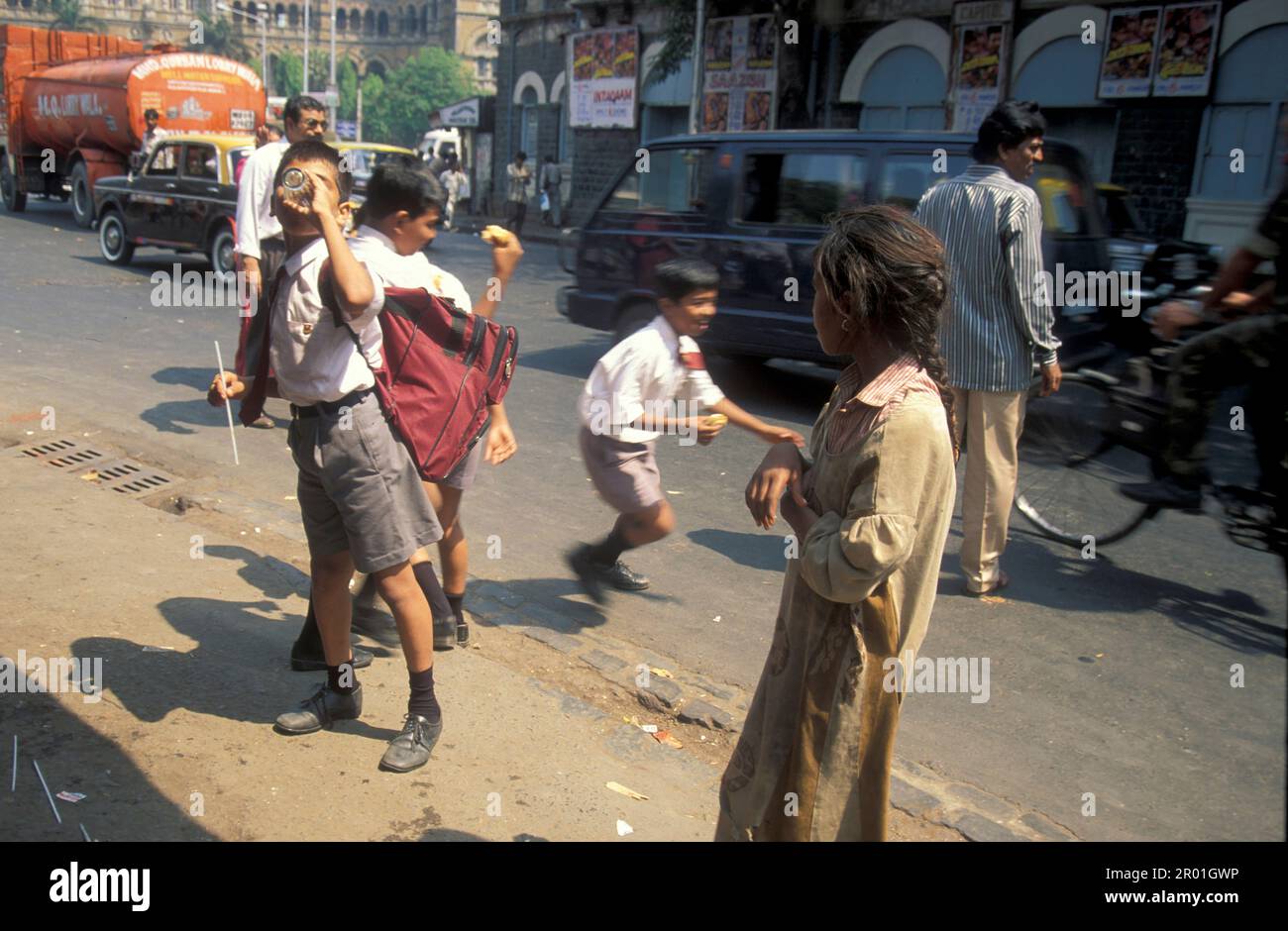 a school Boy and a poor girl meet in front of the Mumbai Railway ...