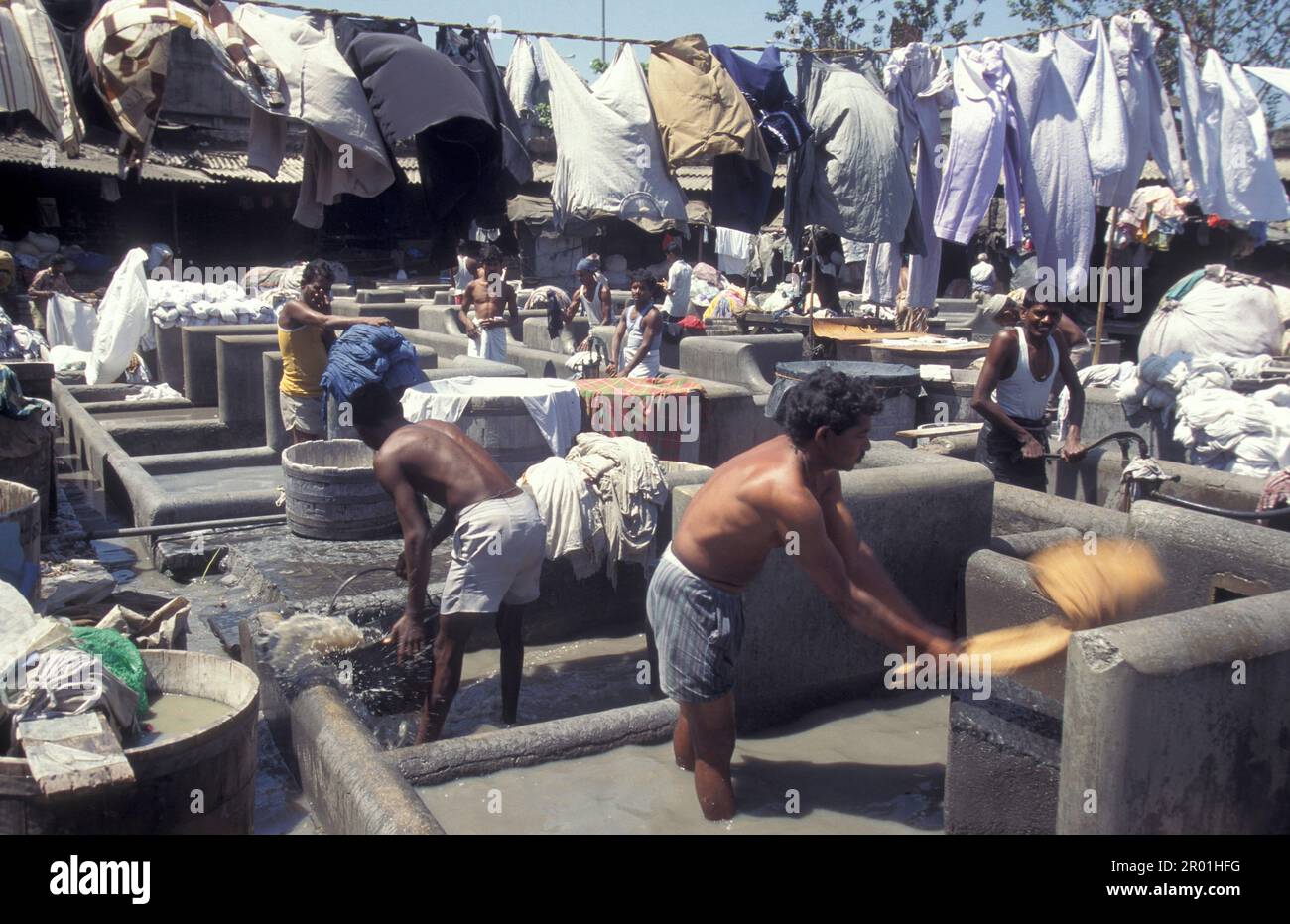 workers at the outdoor Laundry Dhobi Ghat at Mahalaxmi in the city centre of Mumbai in India ...