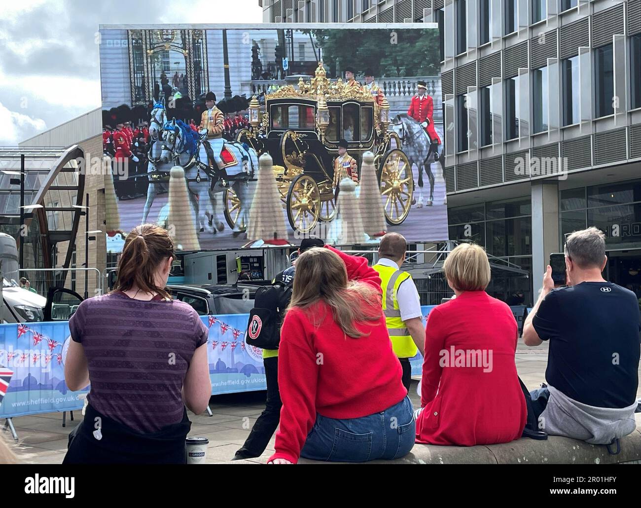 People watching the coronation ceremony of King Charles III and Queen ...