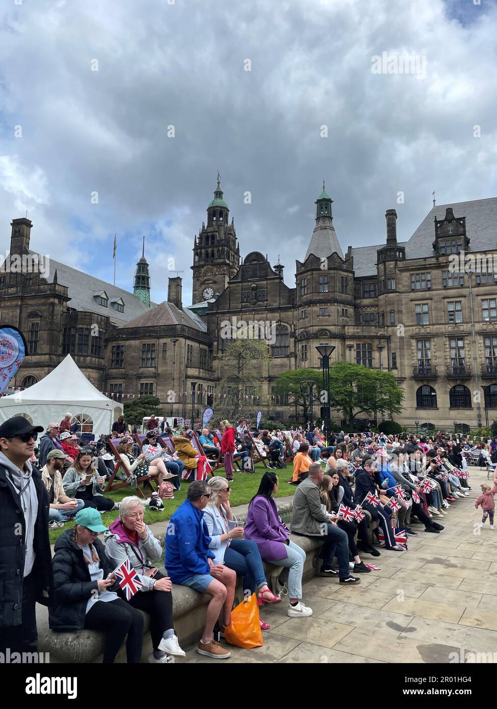 People watching the coronation ceremony of King Charles III and Queen ...