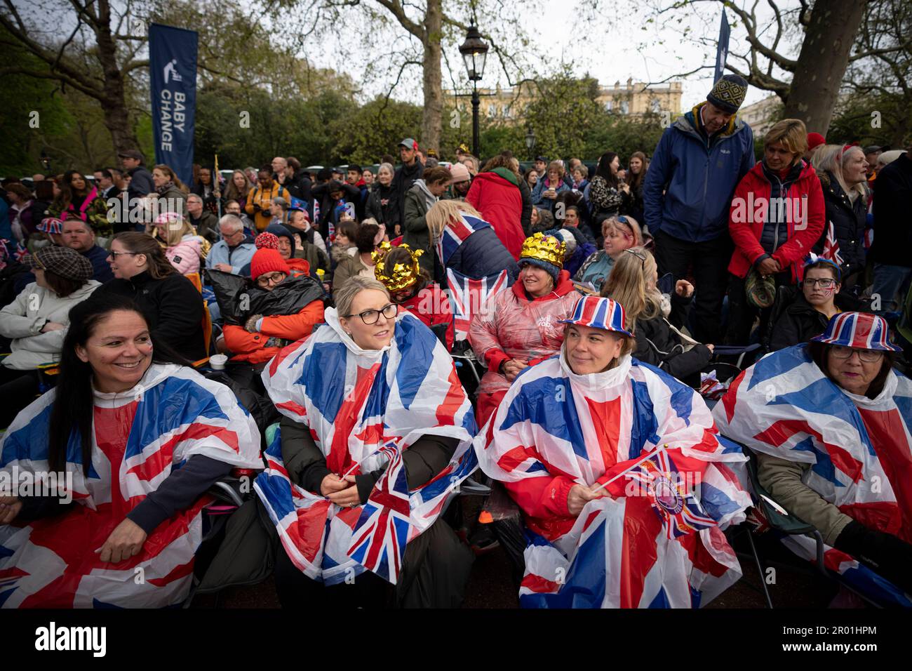 Royal fans wearing Union Jack ponchos await the start of Britain's King ...