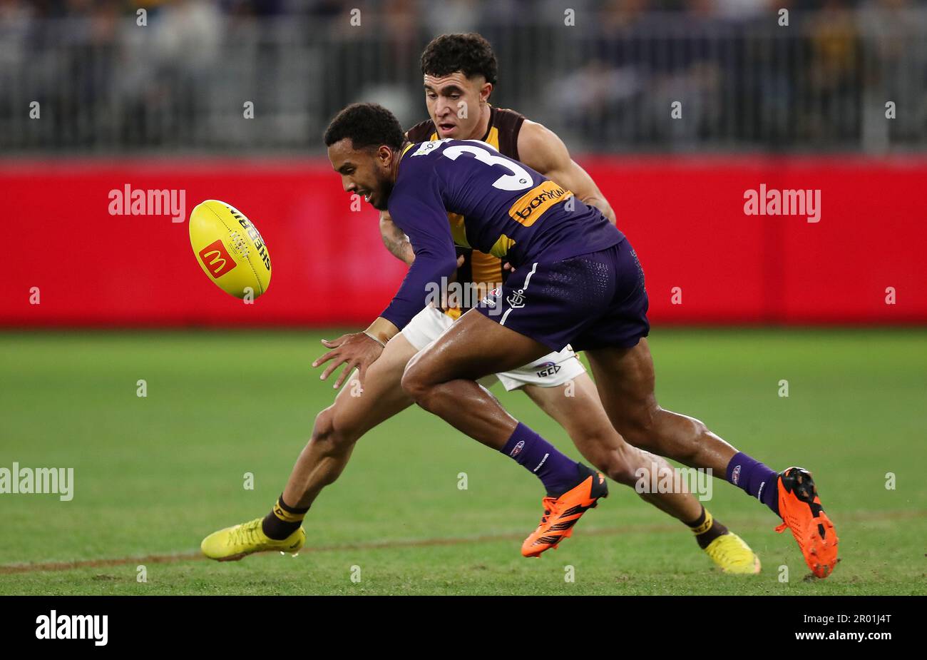 Brandon Walker of the Dockers under pressure from Tyler Brockman of the ...