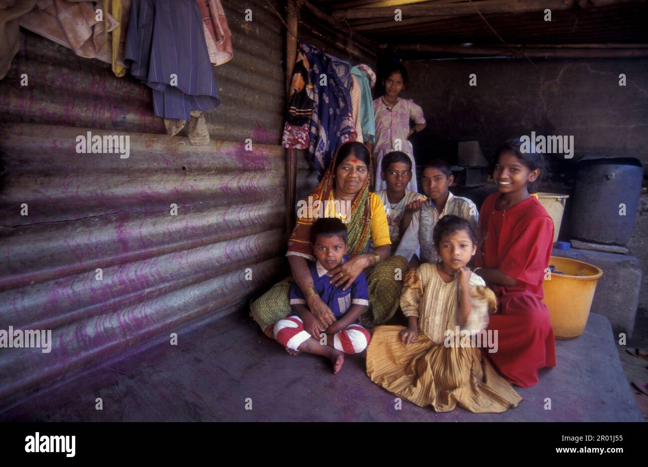 a Indian Family in a village centre of a slum in the city centre of ...