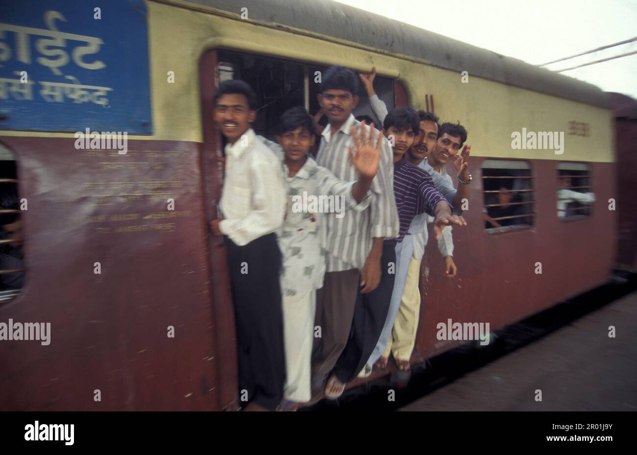 a overloaded Train on the way to the Mumbai Railway Station or ...