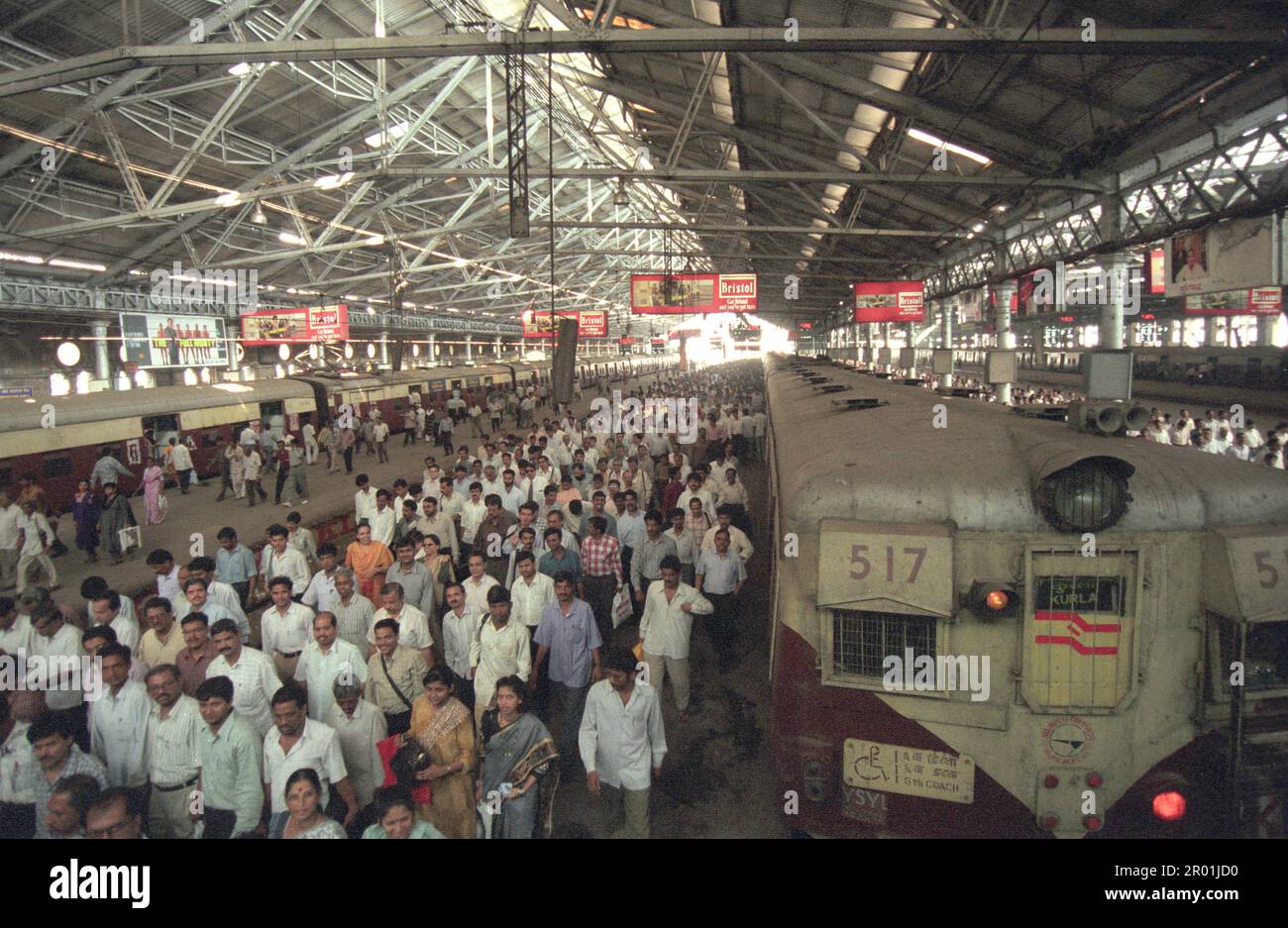 People and trains inside of the Mumbai Railway Station or Chhatrapati ...