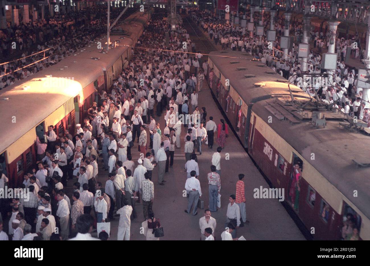 People and trains inside of the Mumbai Railway Station or Chhatrapati ...