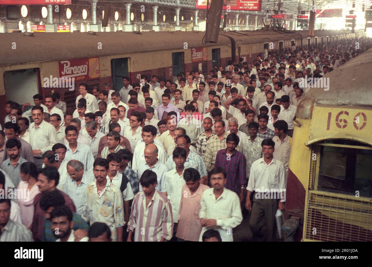 People and trains inside of the Mumbai Railway Station or Chhatrapati ...
