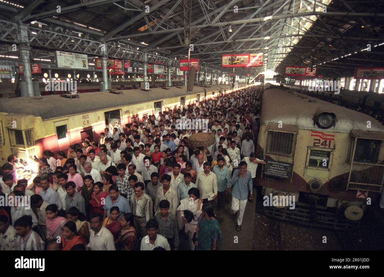 People and trains inside of the Mumbai Railway Station or Chhatrapati ...