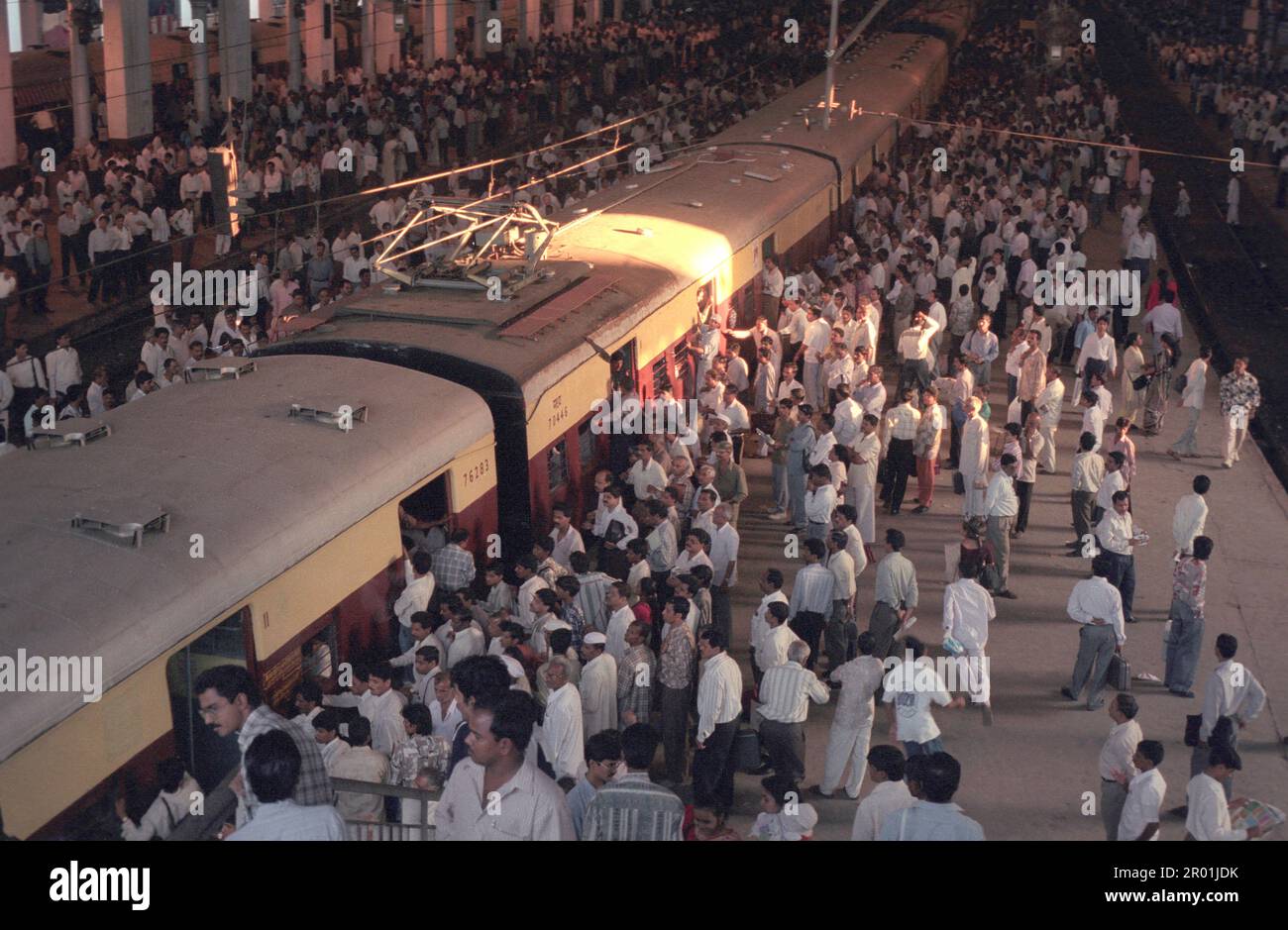 People and trains inside of the Mumbai Railway Station or Chhatrapati ...