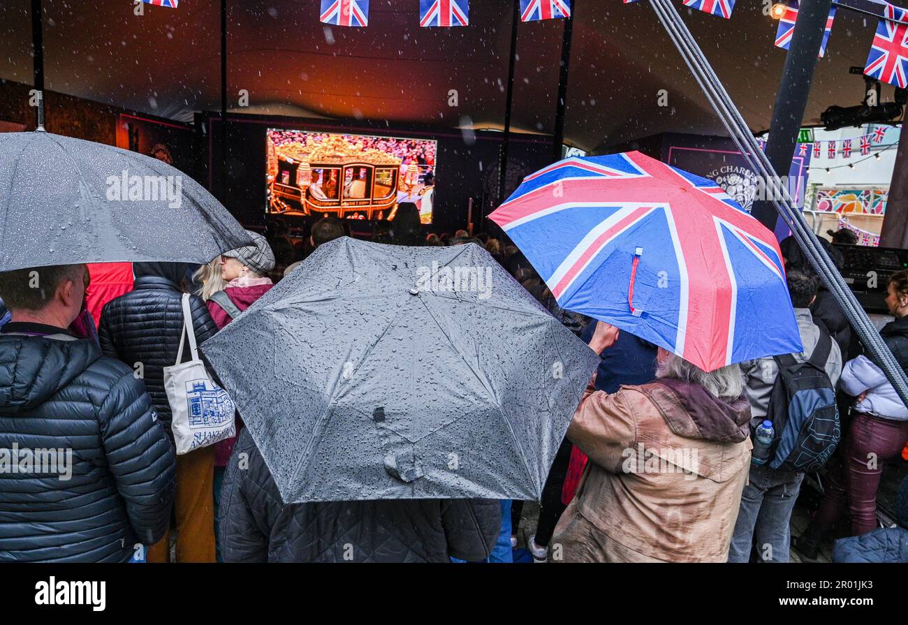 Brighton UK 6th May 2023 - Crowds watch in the rain the Coronation of ...