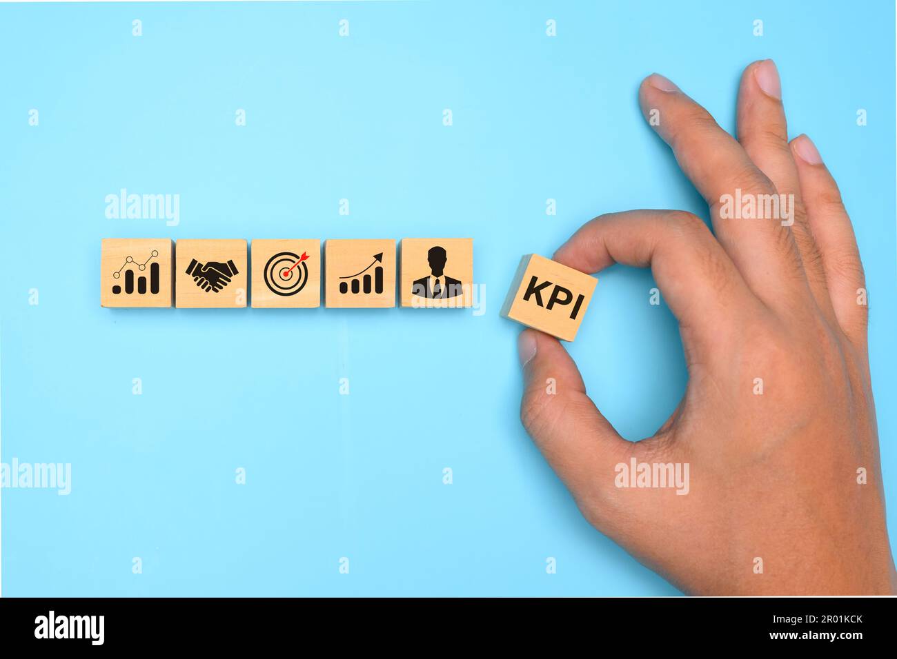 Key performance indicator, Businessman holding wooden cube with KPI ...