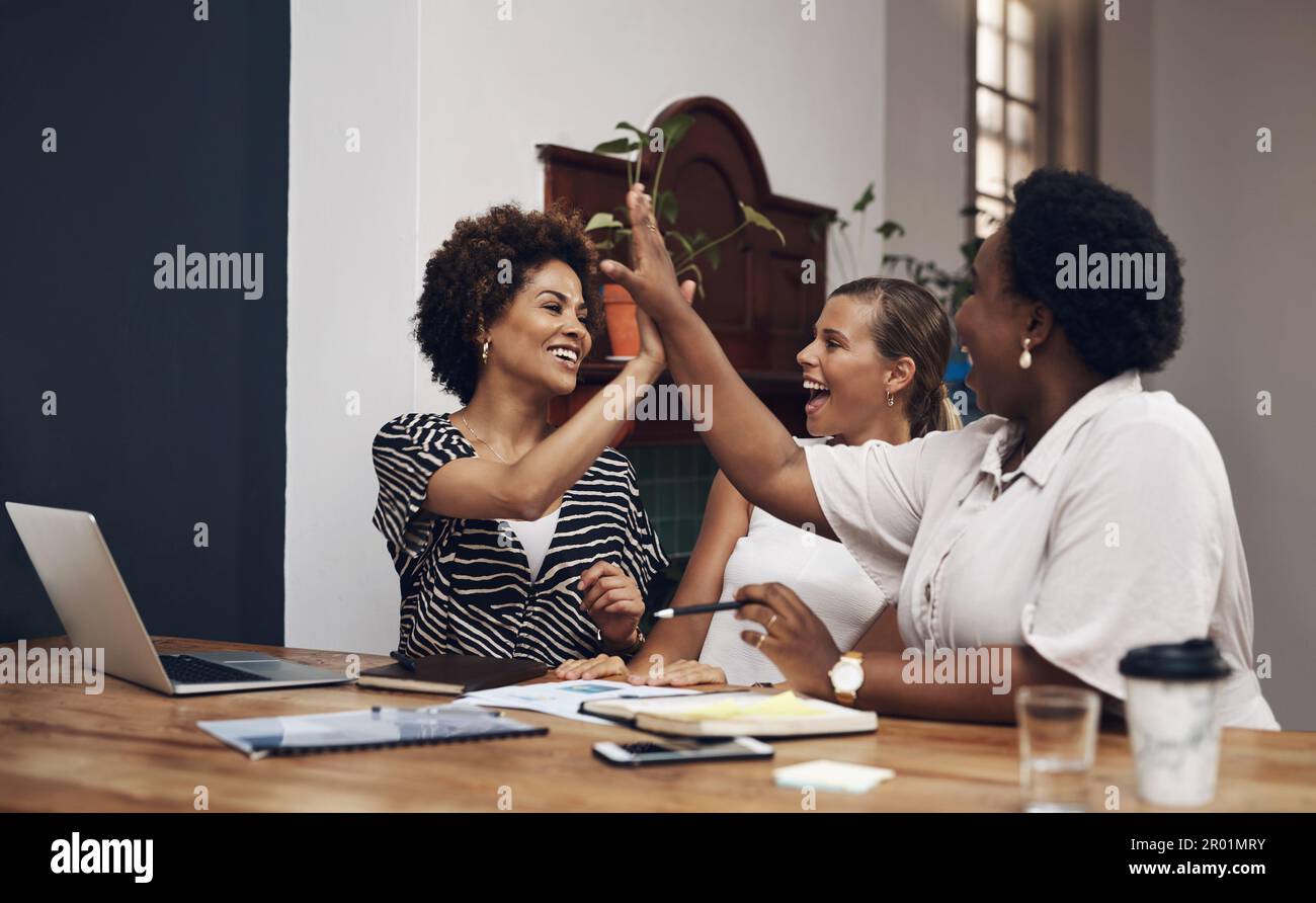 Team solidarity completes any business task. a group of young ...