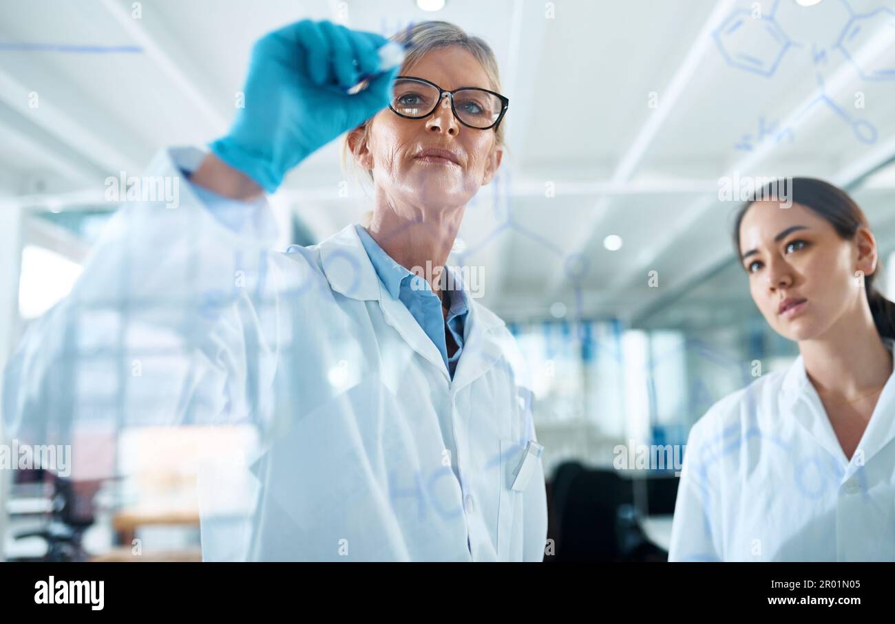 Planning and conducting some new experiments. two scientists drawing ...