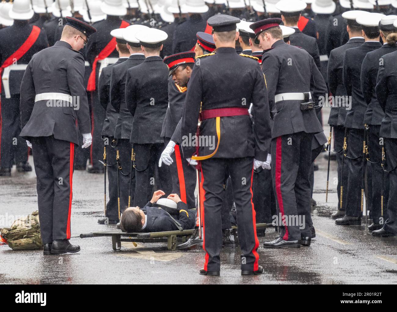 A member of the military is attended to after fainting at Parliament ...