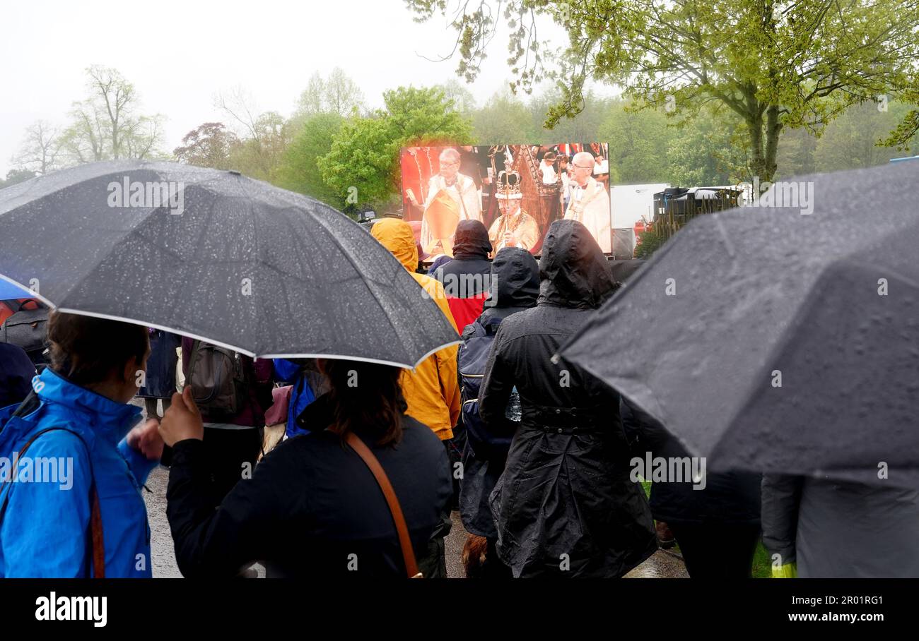 Spectators watch the Coronation of King Charles III on the big screen ...