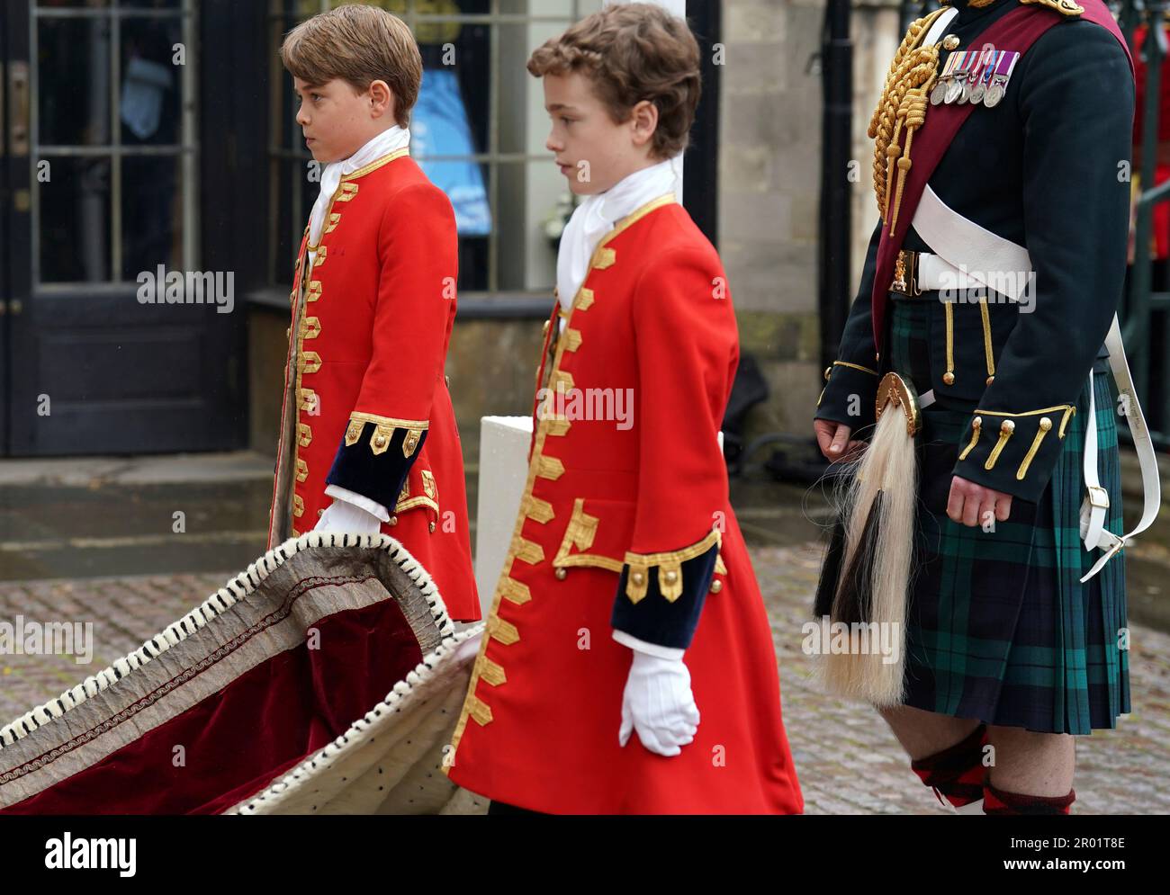 Prince George, background, one of four Pages of Honour, arrives at ...